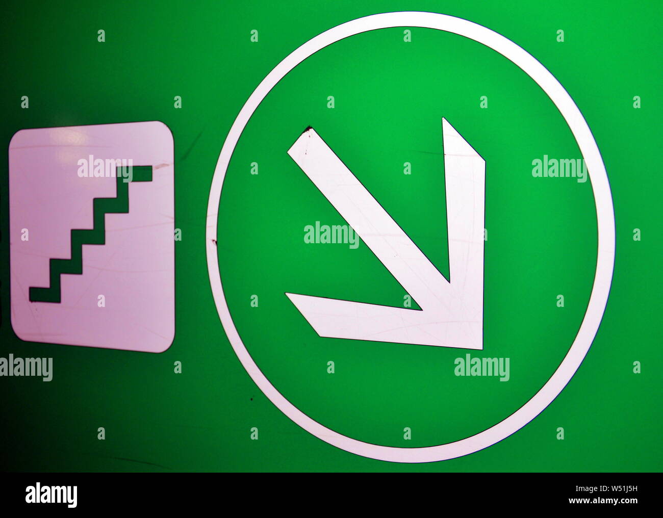 An arrow sign indicating the way to a flight of stairs Stock Photo - Alamy