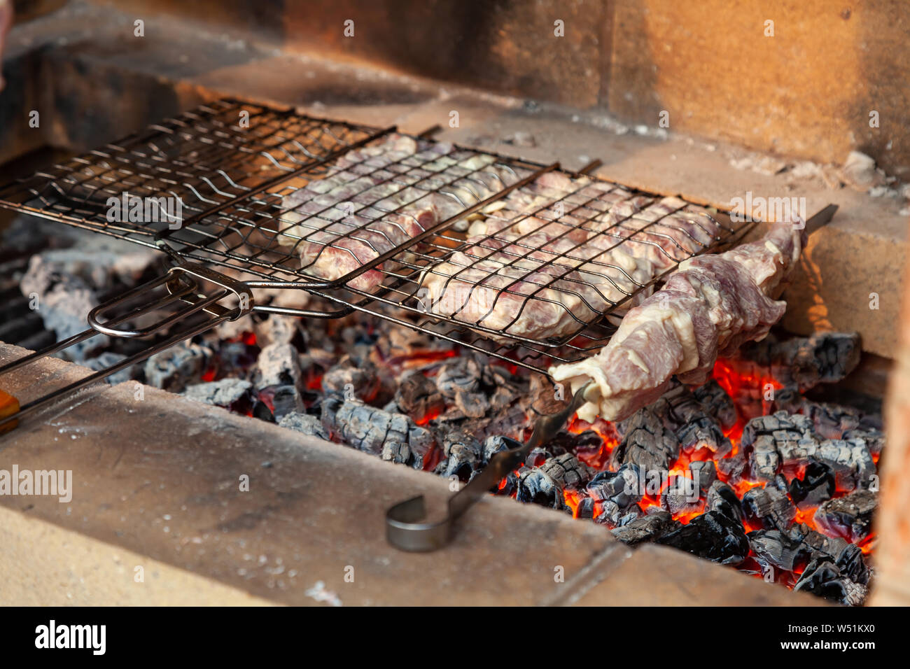 Close-up on the process of cooking barbecue of pork or beef meat ...