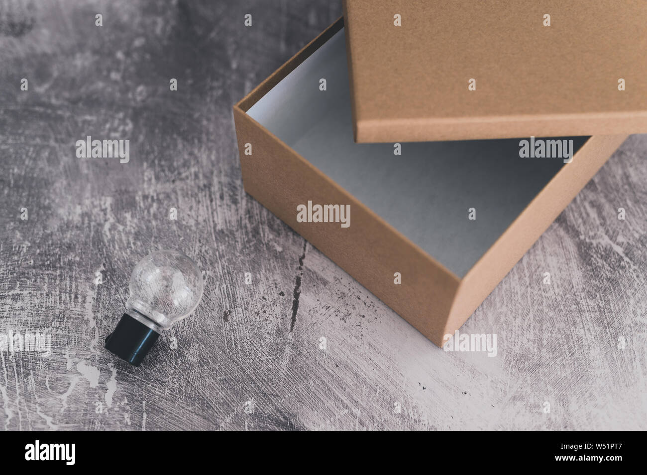 think outside the box concept: open empty box with one lightbulb ...