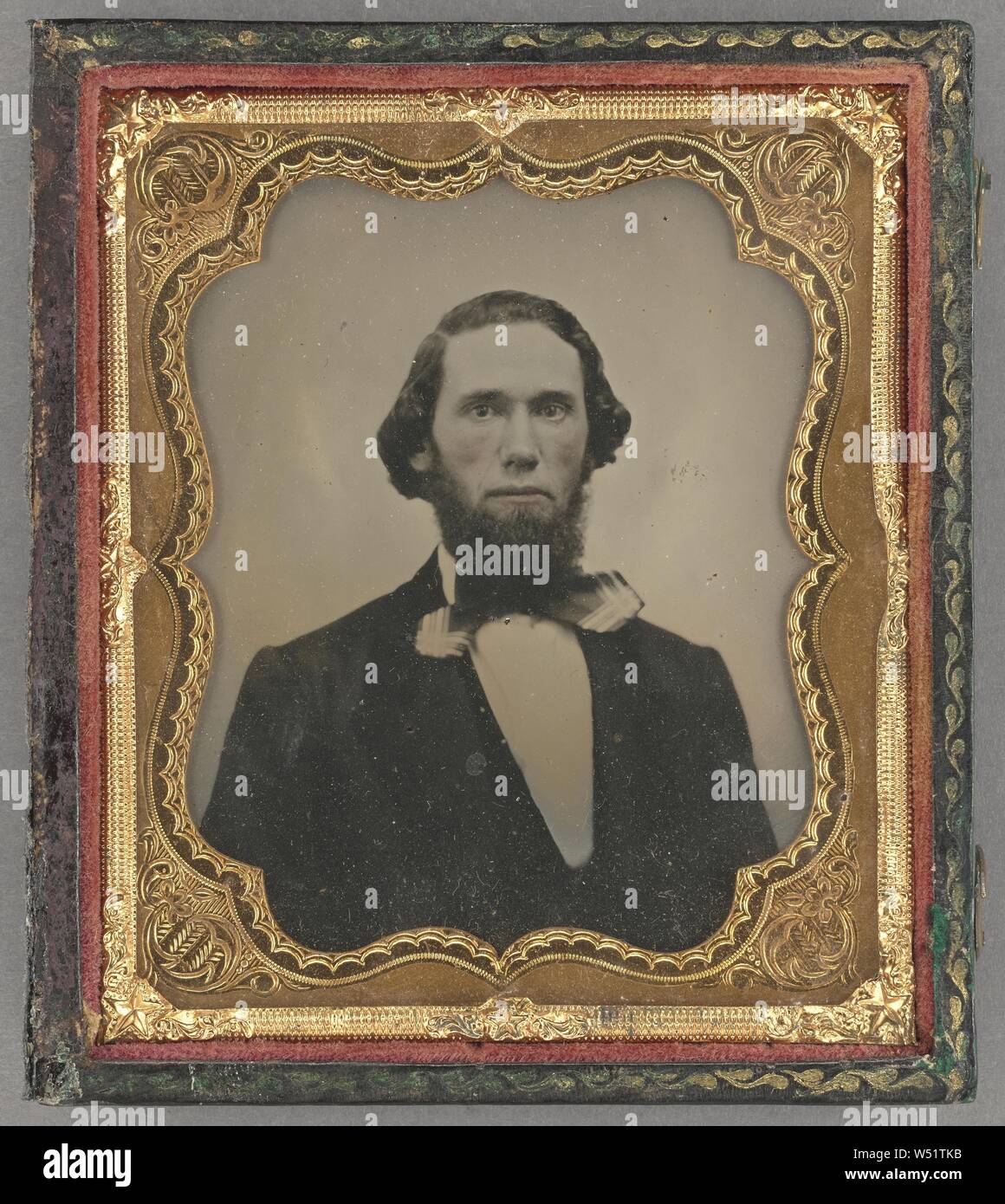 Portrait Of A Seated Man With Chin Beard And Long Hair In Bow Tie