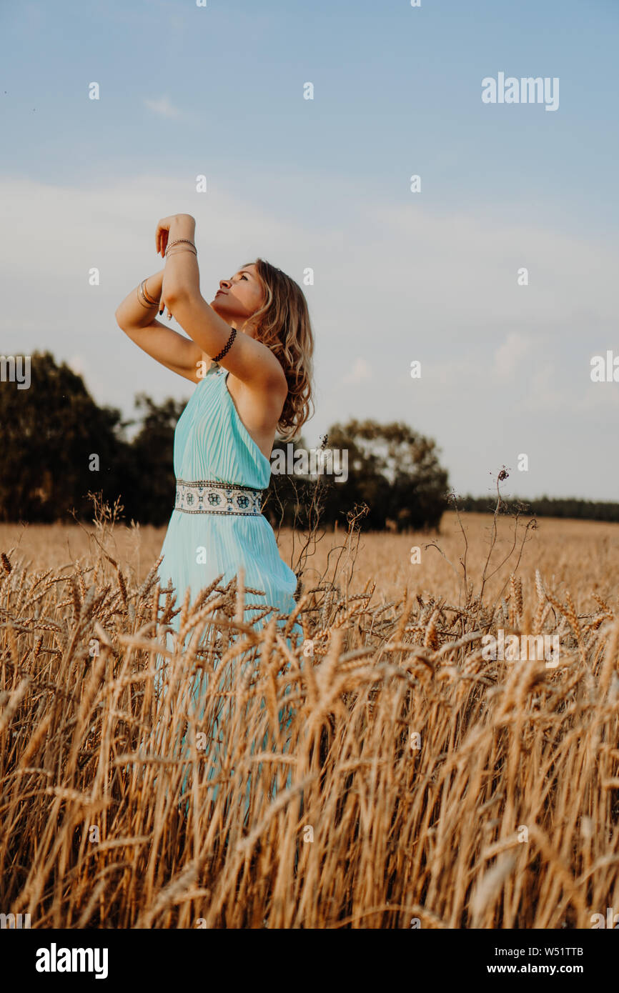 Beautiful Young Woman Dancing In The Field at sunset Stock Photo - Alamy
