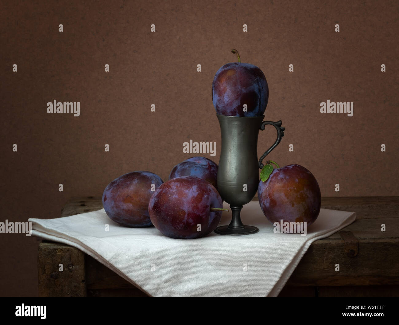 Red plums still life. Light painting Stock Photo - Alamy
