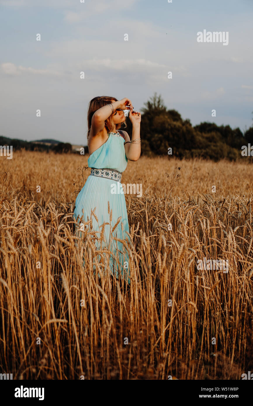 Beautiful Young Woman Dancing In The Field at sunset Stock Photo - Alamy