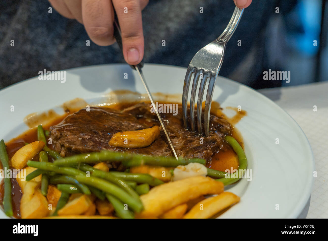 Hands using fork knife hi-res stock photography and images - Alamy