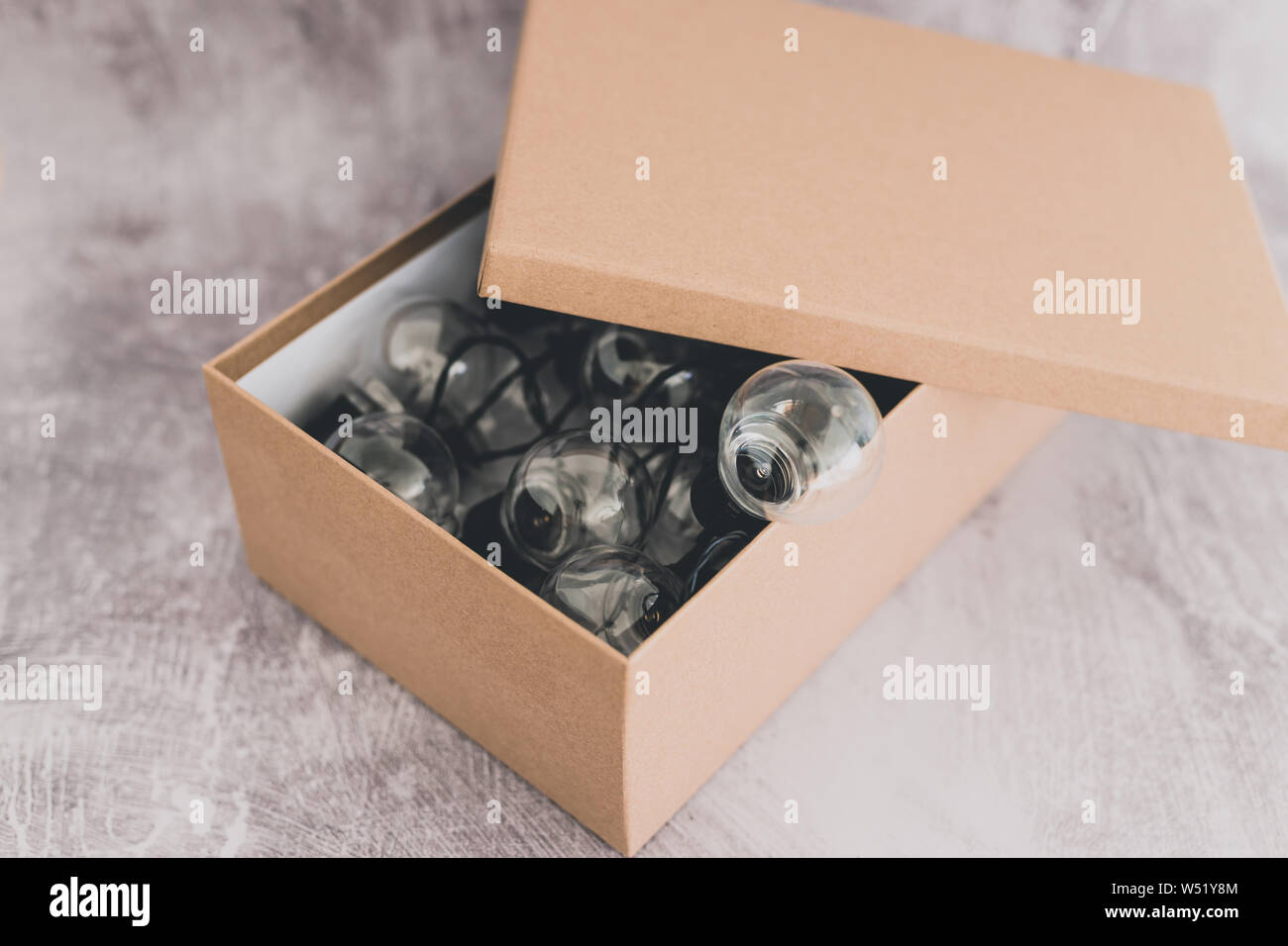 think outside the box concept: open box with miniature lightbulb going ...