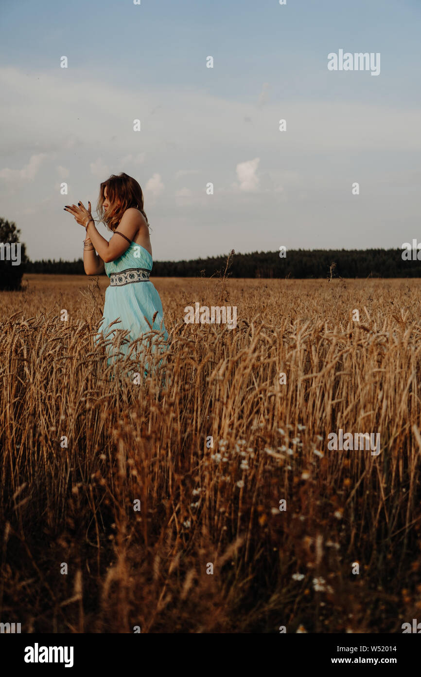 Beautiful Young Woman Dancing In The Field at sunset Stock Photo - Alamy