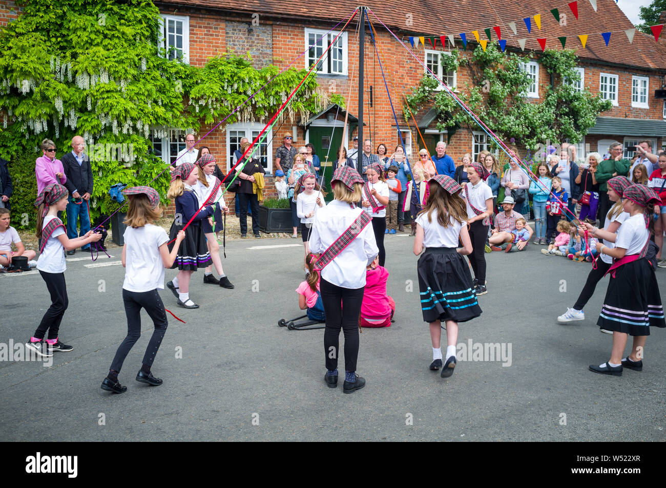 Children from the local primary school dancing around the traditional ...