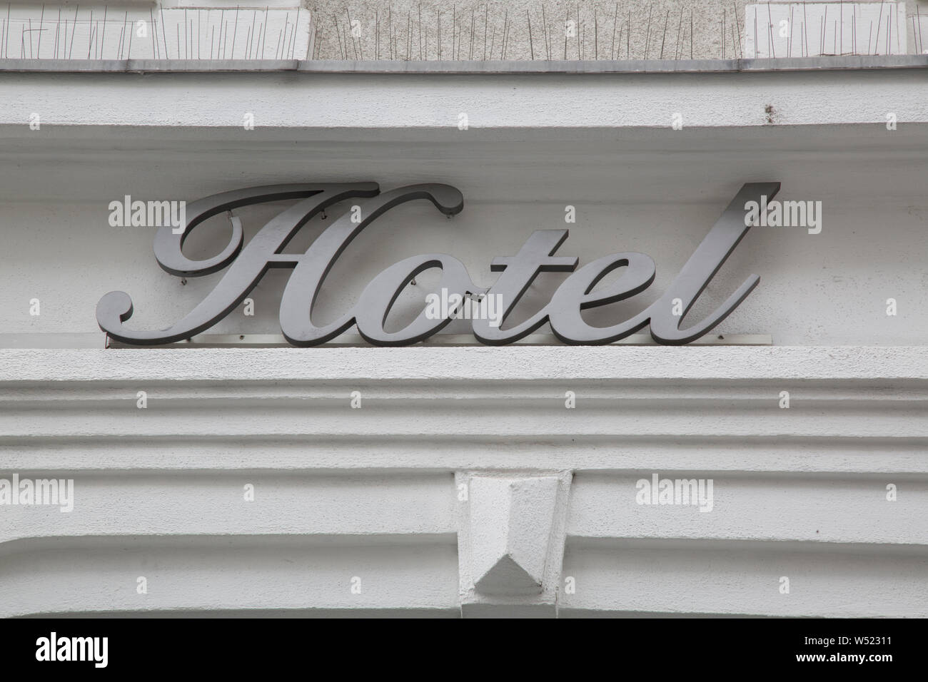 Silver Hotel Sign on Building Facade Stock Photo - Alamy
