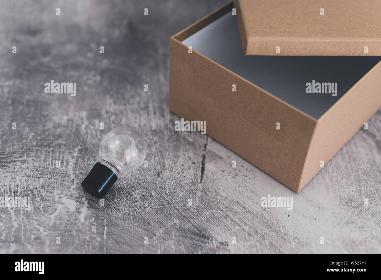 think outside the box concept: open empty box with one lightbulb ...