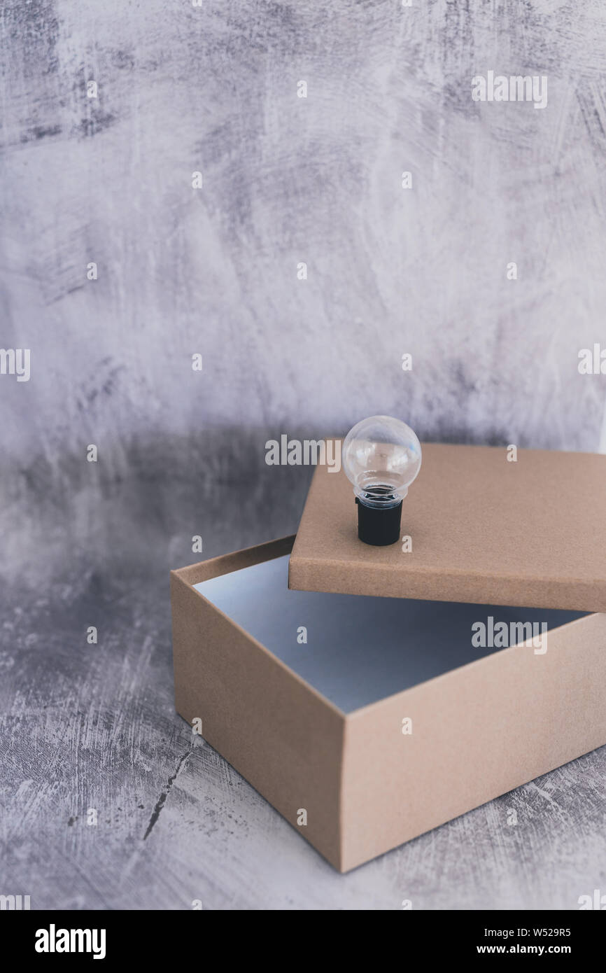 think outside the box concept: open empty box with one lightbulb ...