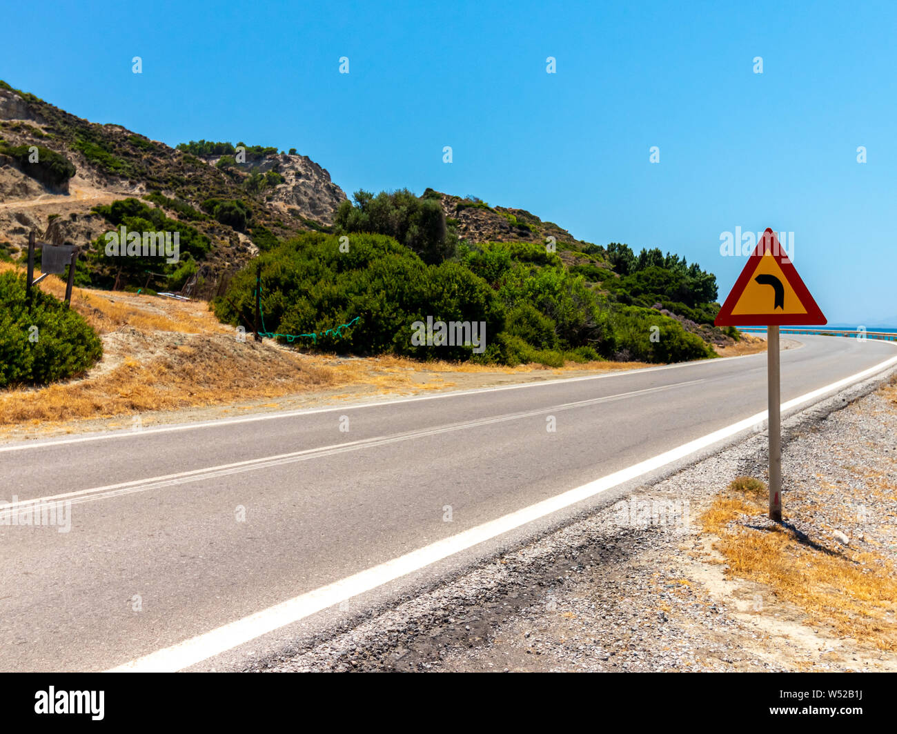 Lonely road with road sign in the middle of a beautiful landscape in ...