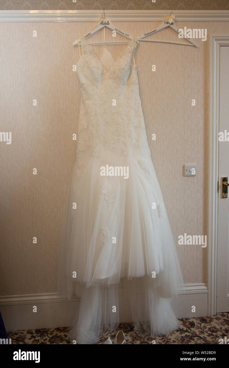 Wedding Dress hanging up waiting to be worn on the Brides wedding day ...