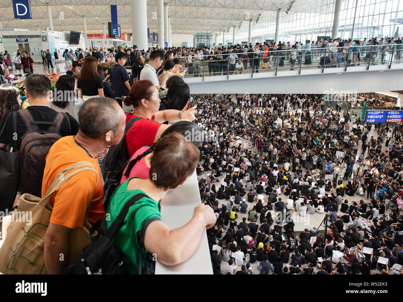 Travelers watch hundreds of anti government protesters staged a sit in ...