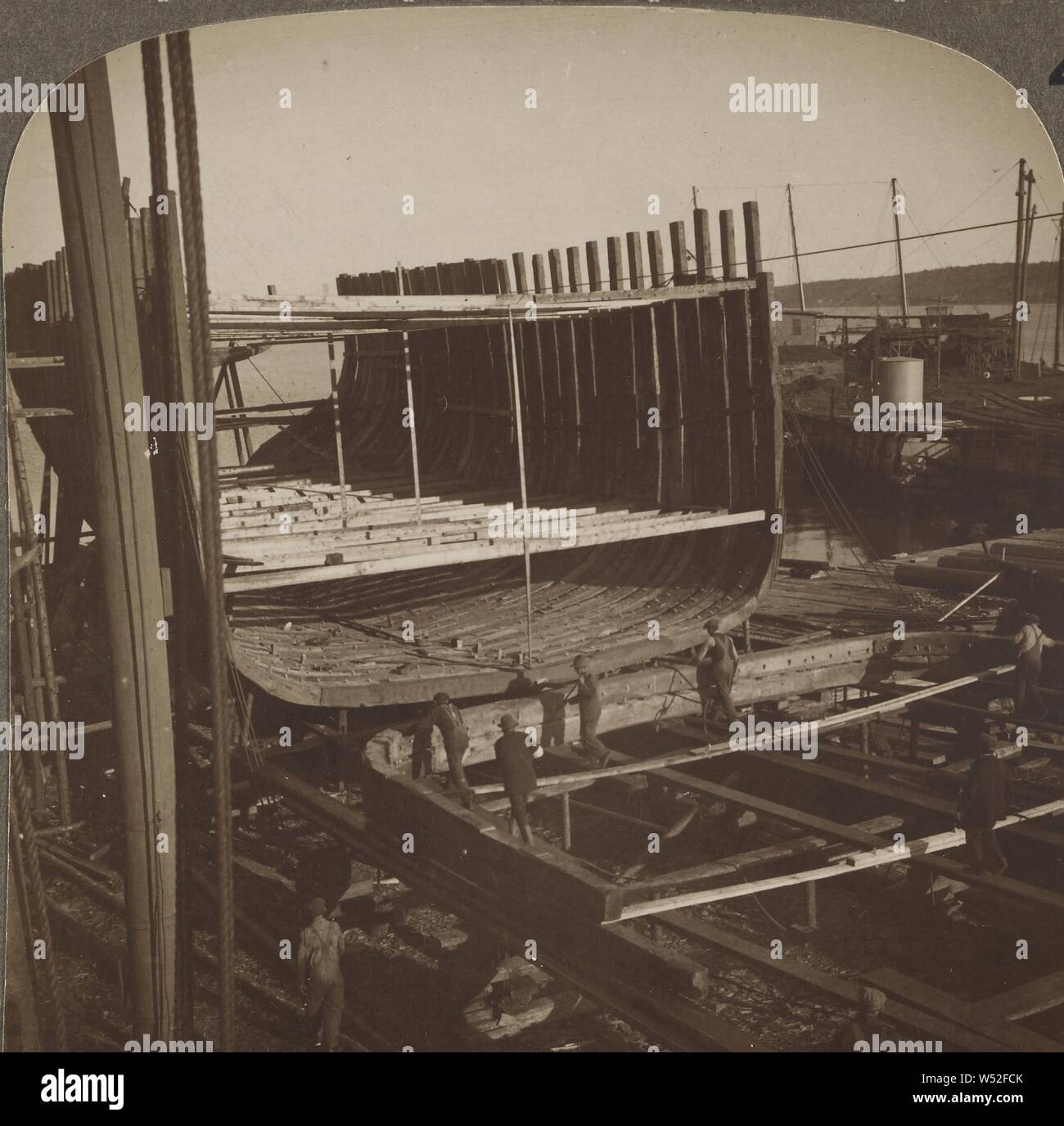 Sliding framed rib along keel, preparatory to raising it, ship yard ...