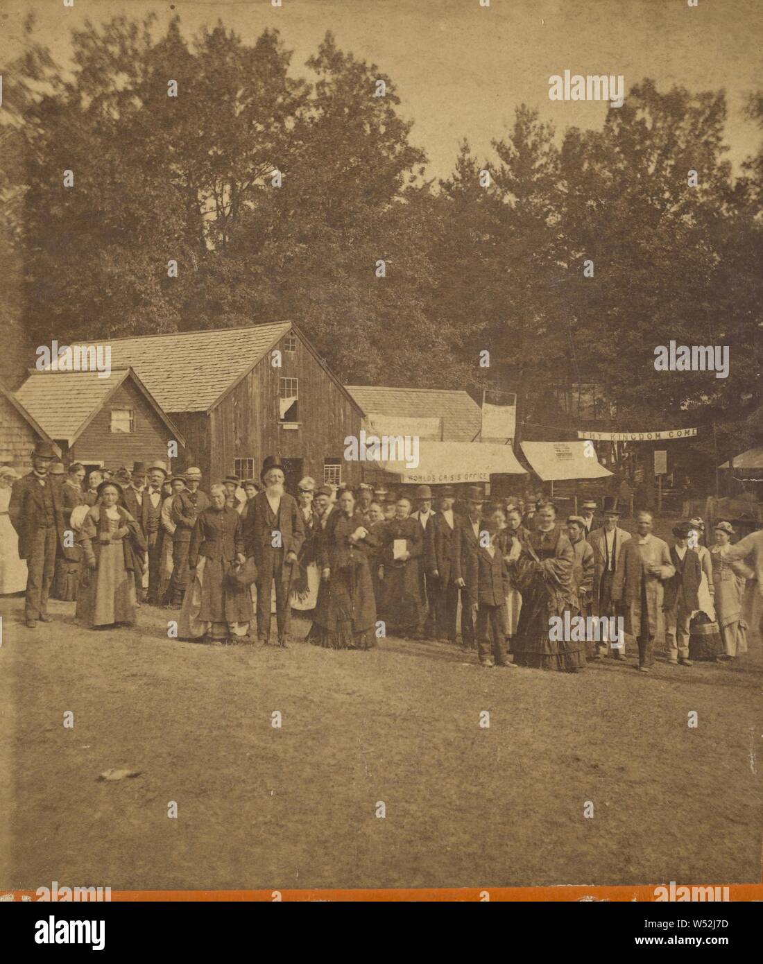 Large group of people posed in front of a building with World's Crisis ...
