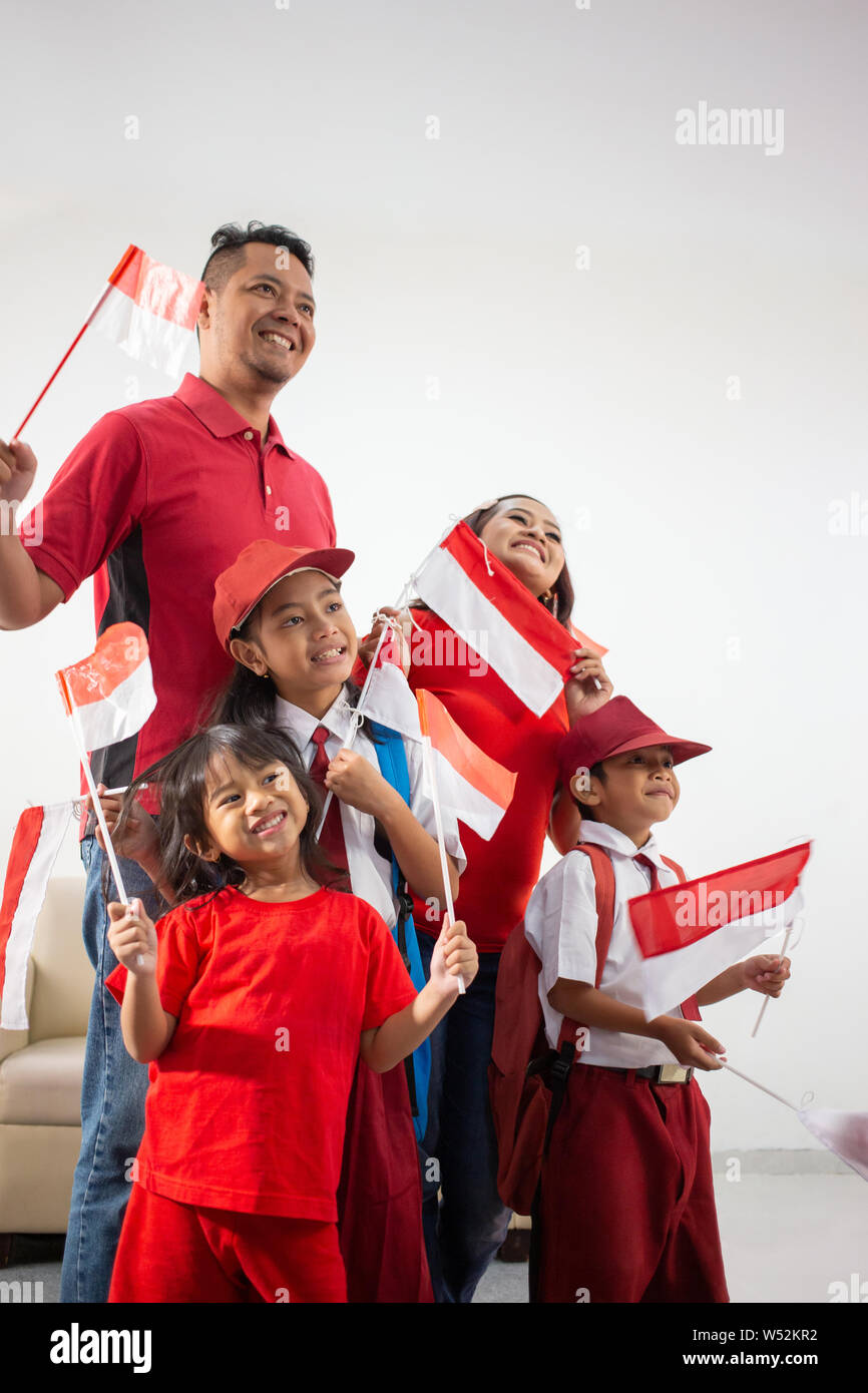 indonesian family holding indonesia flag over white background Stock ...