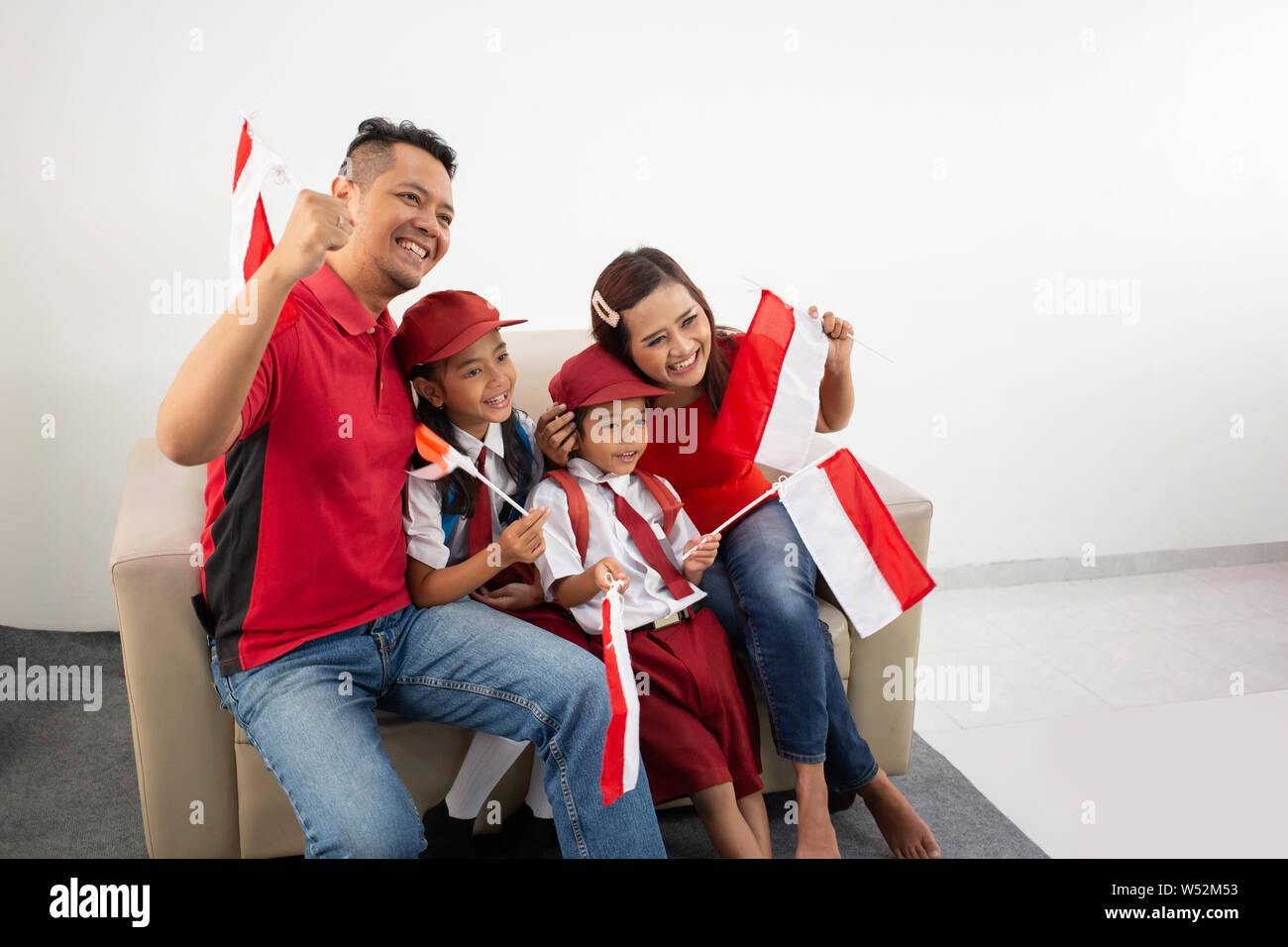 indonesian family holding indonesia flag over white background Stock ...