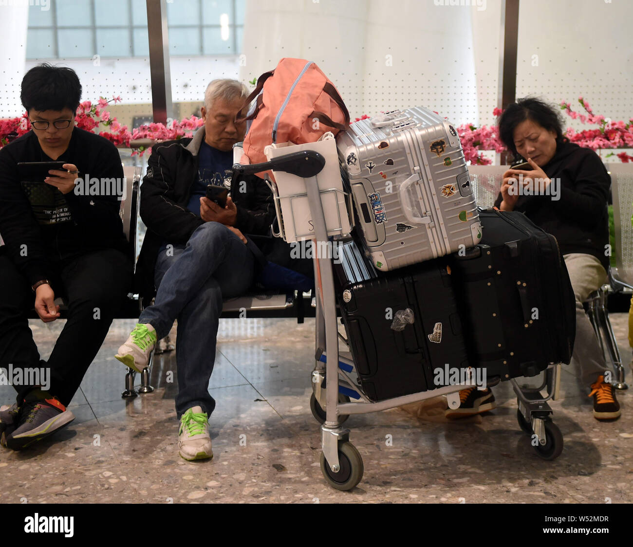 Passengers wait for their trains during the Spring Festival travel rush ...