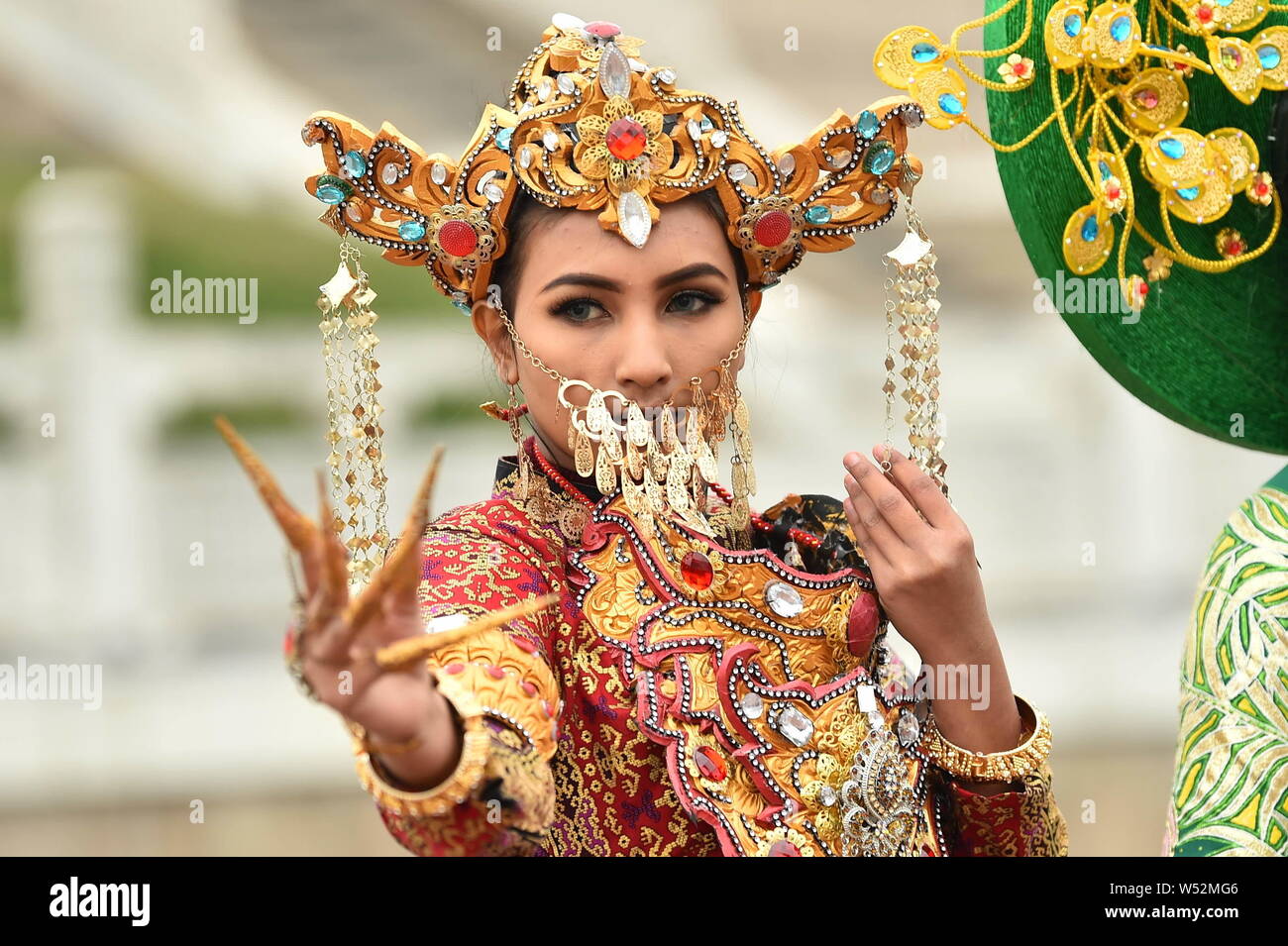 A contestant dressed in a traditional costume takes part in an outdoor ...