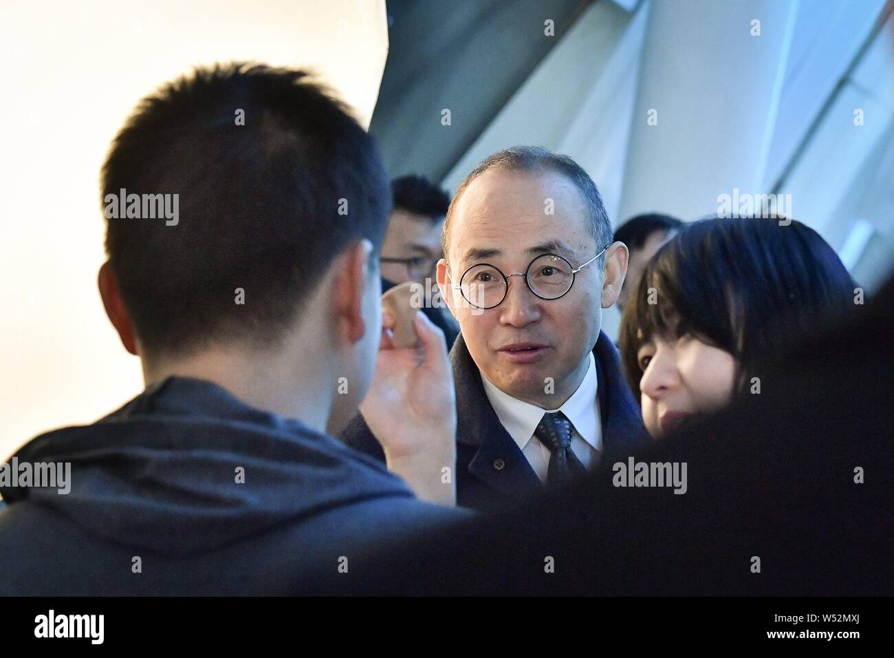 Pan Shiyi, co-founder, Chairman and co-CEO of SOHO China, takes photos for a guest during the ...