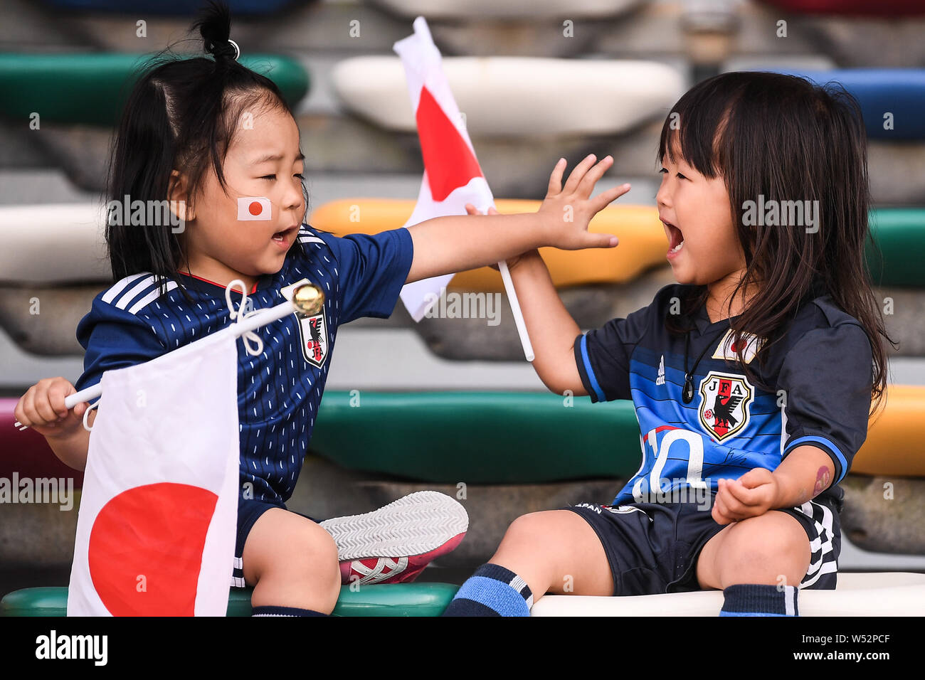 Japanese football fans wave their national flags to show support for ...