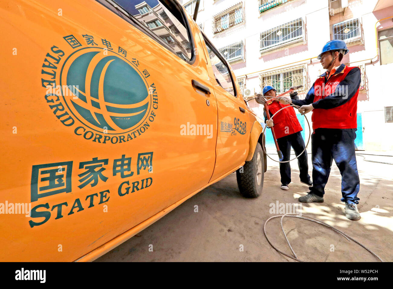 --FILE--Chinese employees of State Grid Corp of China are seen in ...