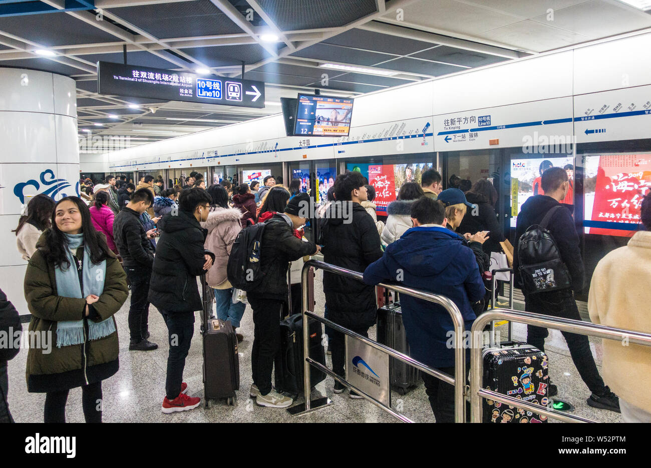 Passengers use smartphones at China's first 5G subway station ...