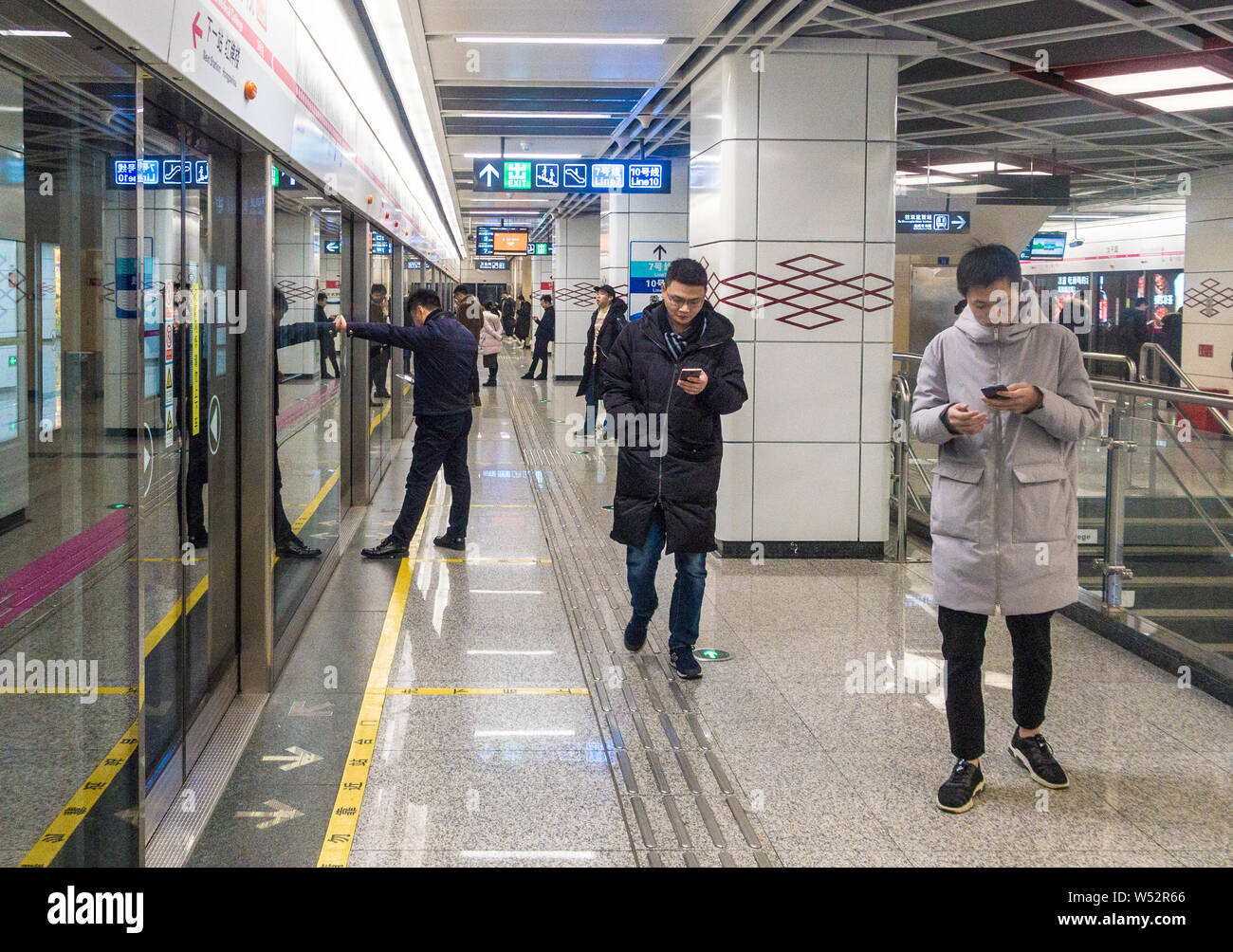 Passengers use smartphones at China's first 5G subway station ...