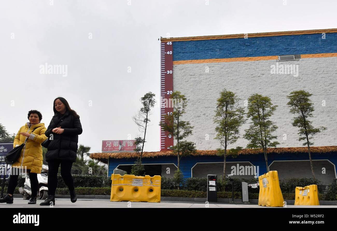 Pedestrians walk past a giant thermometer showing the current outdoor ...