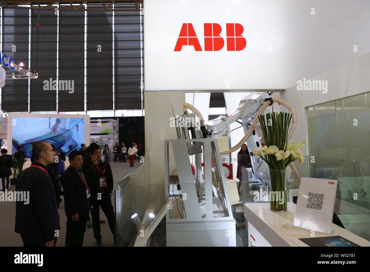 --FILE--People visit the stand of global robotics giant ABB during the ...