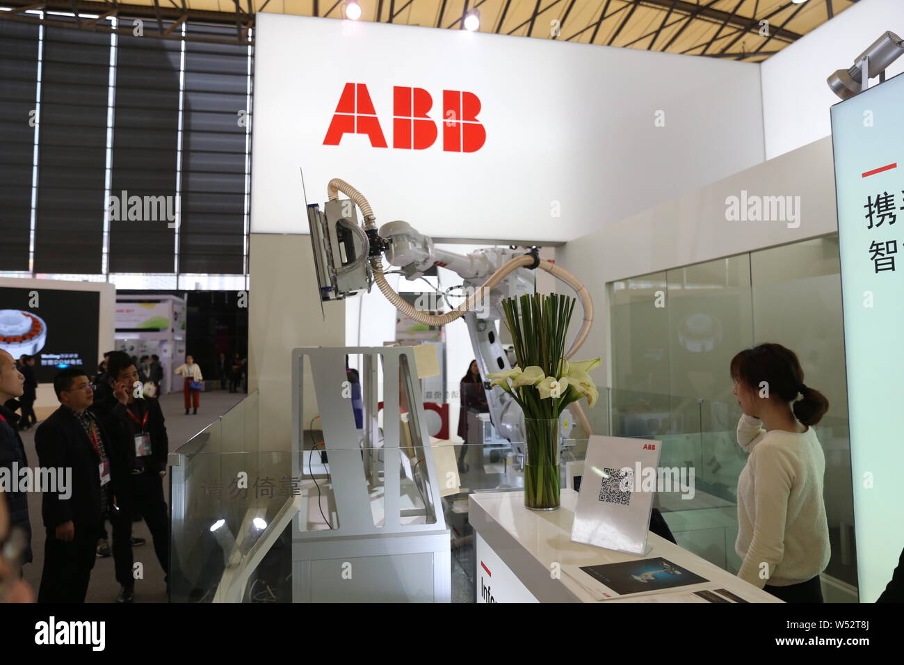 --FILE--People visit the stand of global robotics giant ABB during the ...
