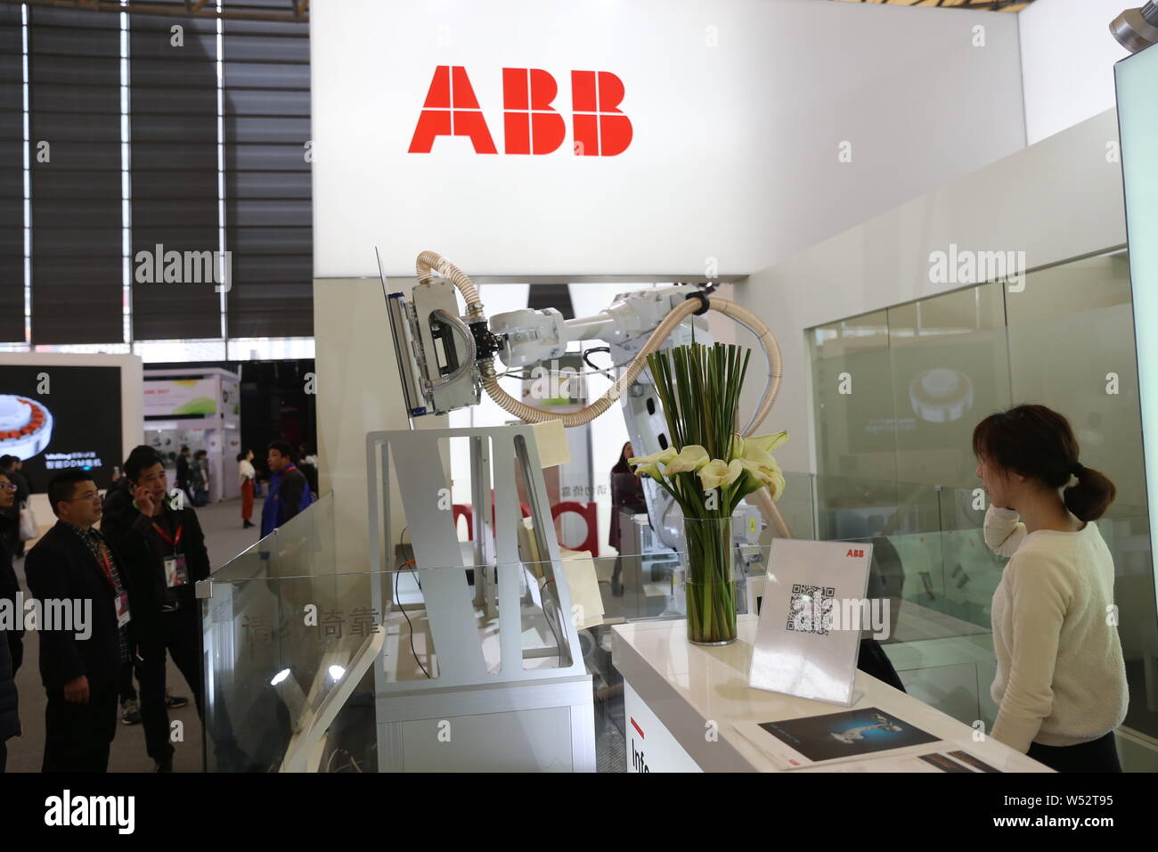 --FILE--People visit the stand of global robotics giant ABB during the ...