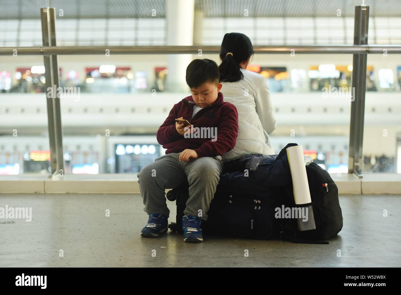 Passengers wait for their trains to go back home for the Chinese Lunar ...