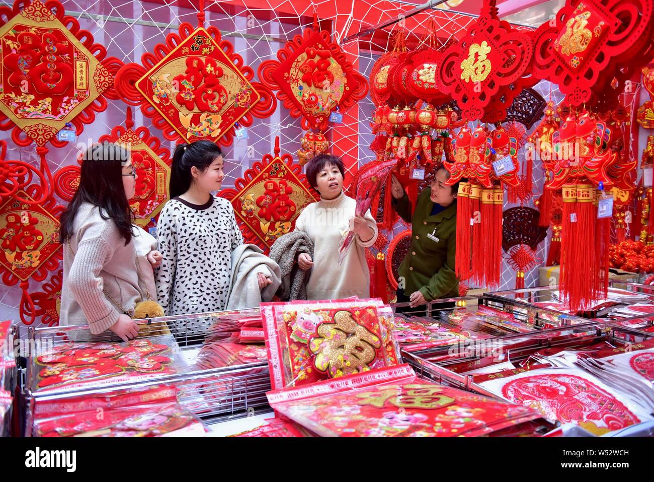 --FILE--Customers shop for red lanterns, decals and other decorations ...