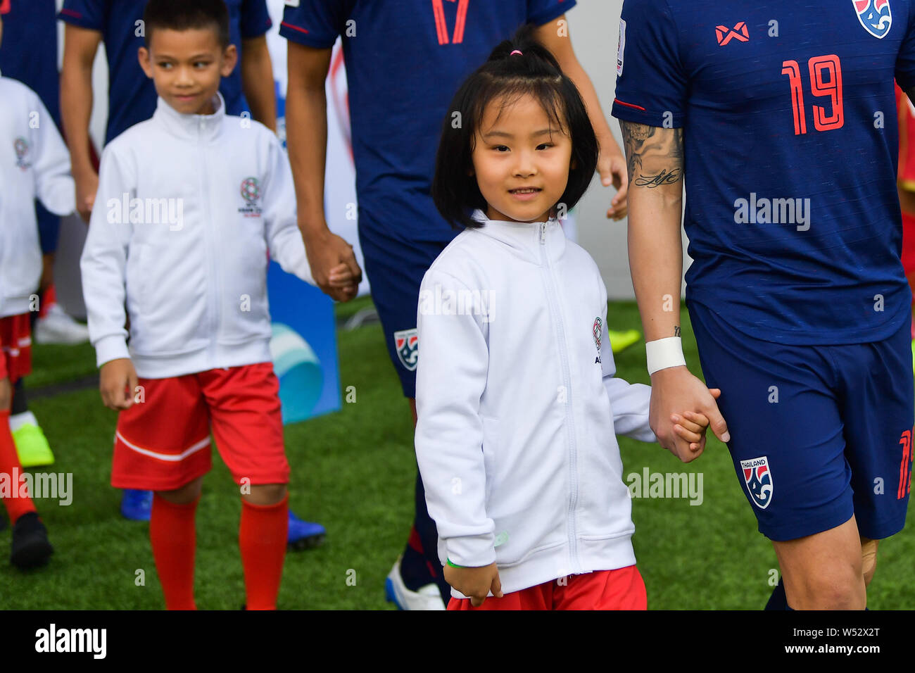 Chinese ball kids arrive for the Group A match between Bahrain and ...