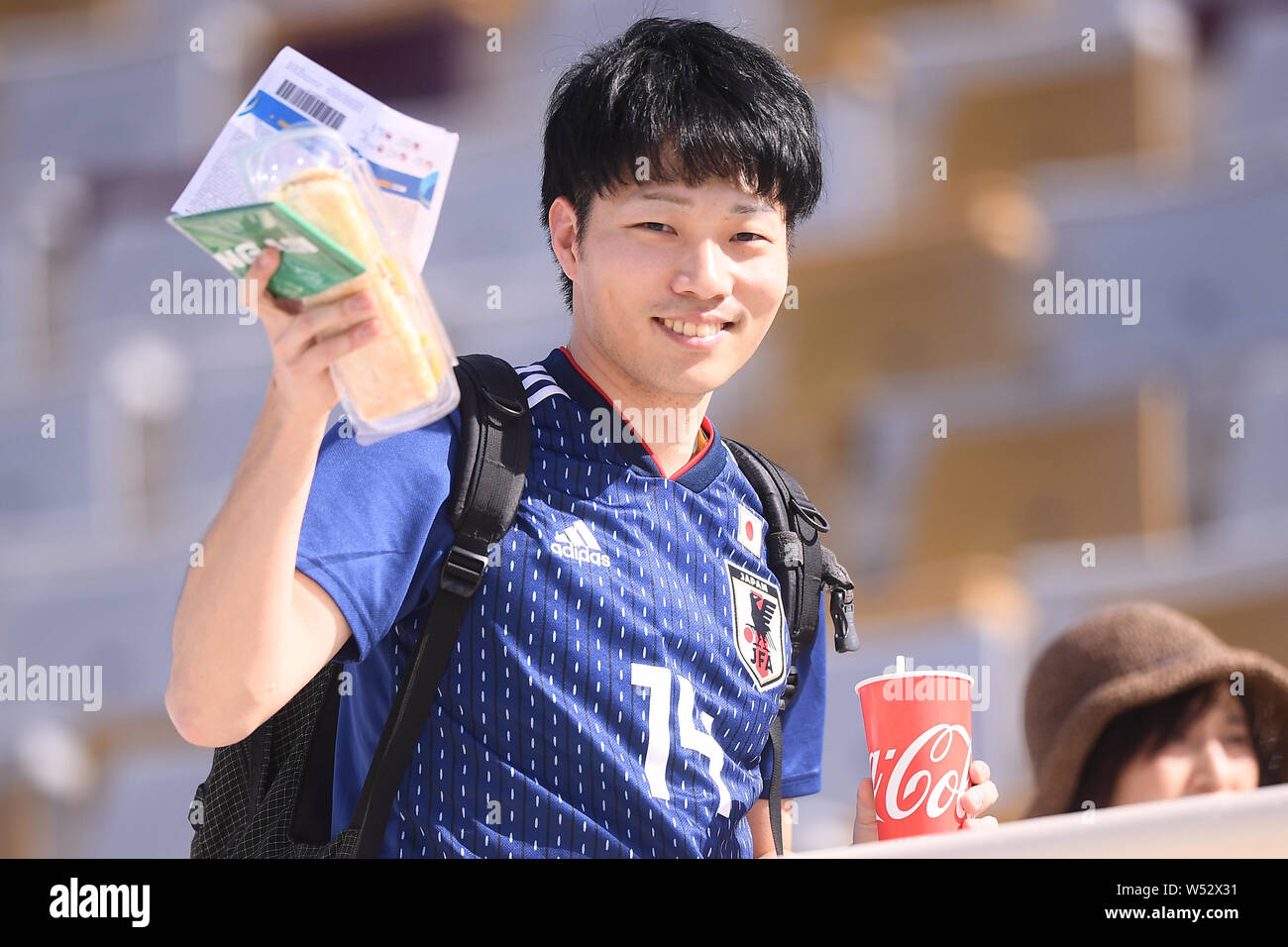 Japanese football fans wave their national flags to show support for ...