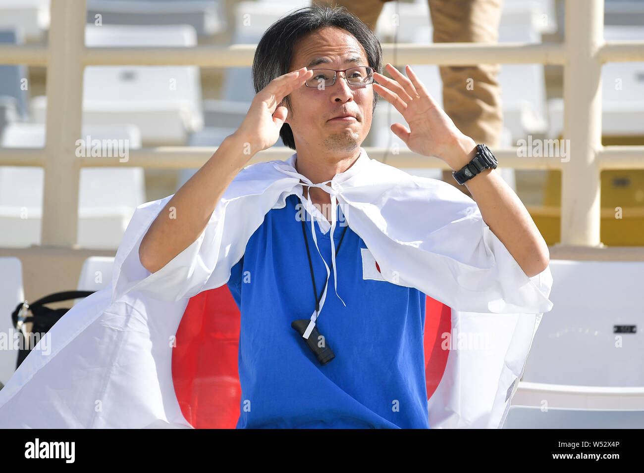 Japanese football fans wave their national flags to show support for ...