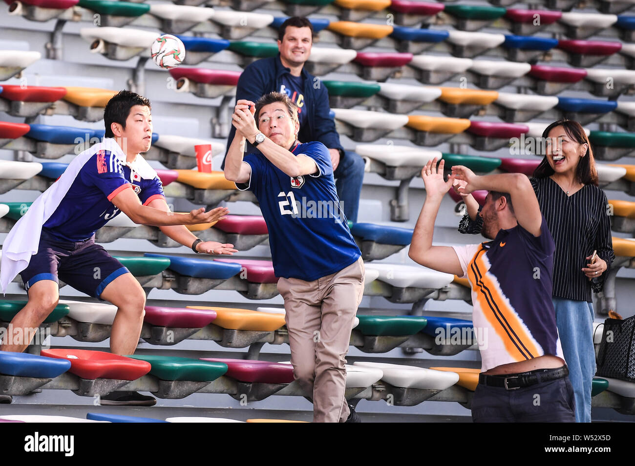 Japanese football fans wave their national flags to show support for ...