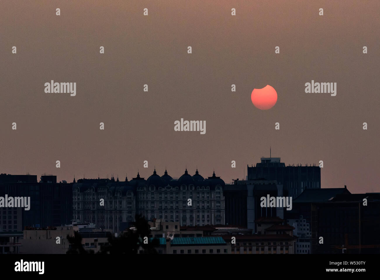 A partial solar eclipse is seen from the Jingshan Park in Beijing ...
