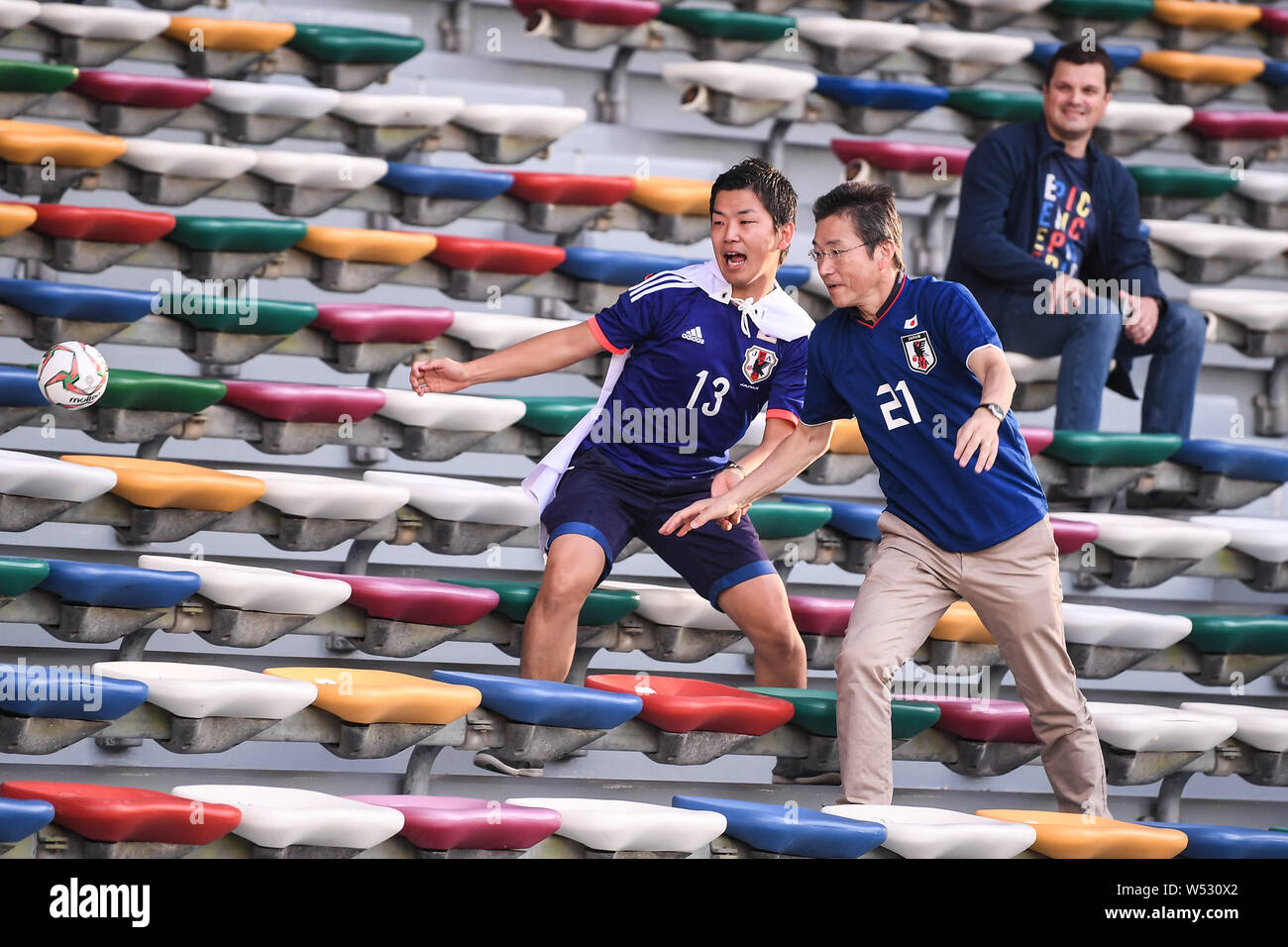 Japanese football fans wave their national flags to show support for ...