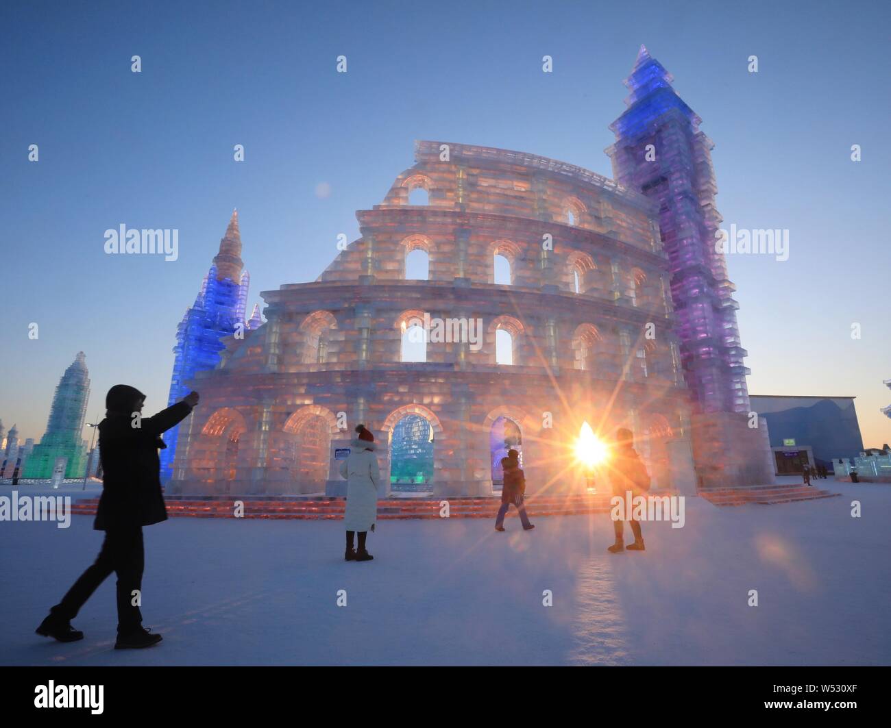 Visitors take pictures or view a downsized ice replica of part of The ...
