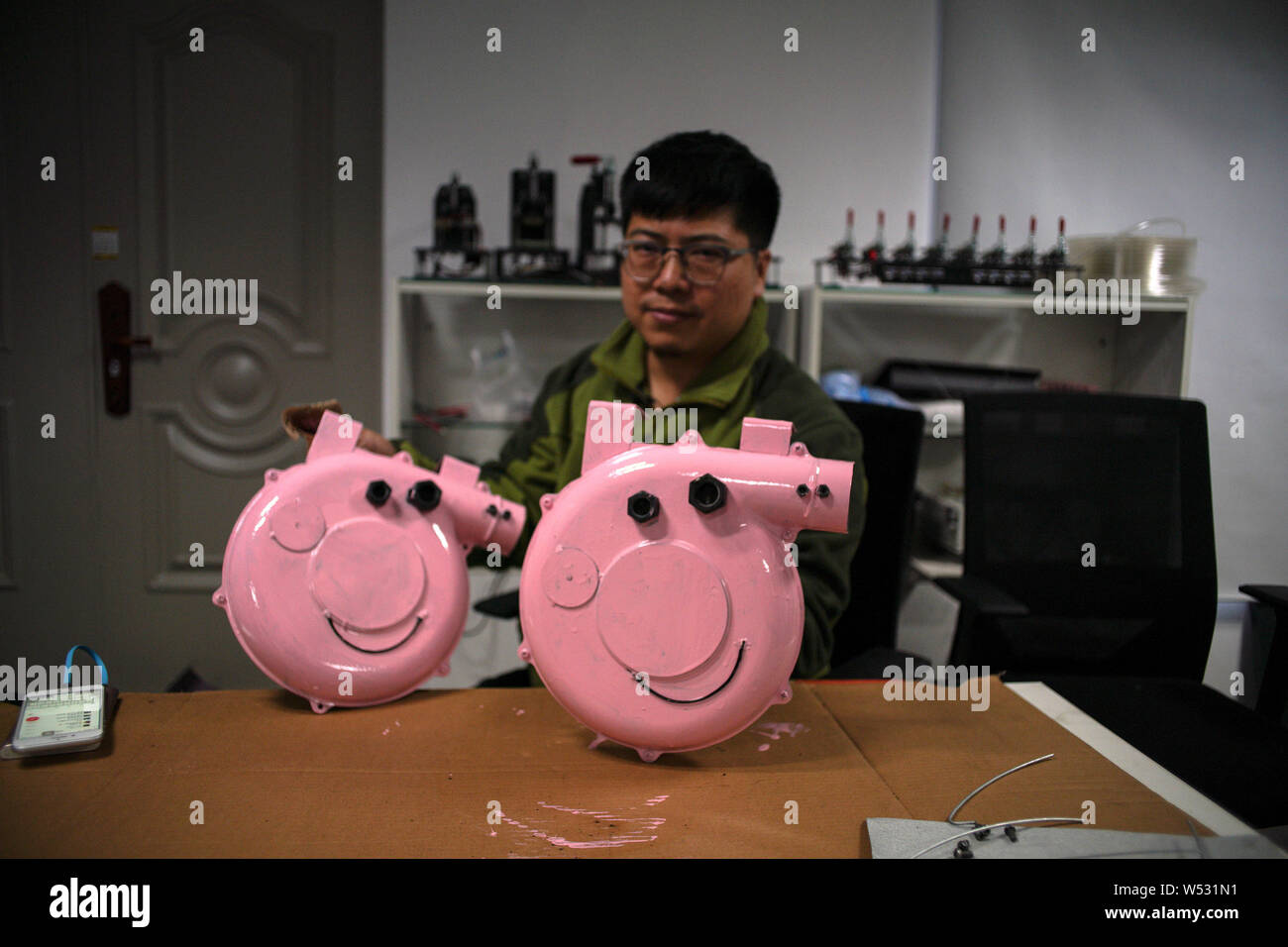 Chinese Peppa Pig fan Han Bing poses with two finished "Iron Peppa ...