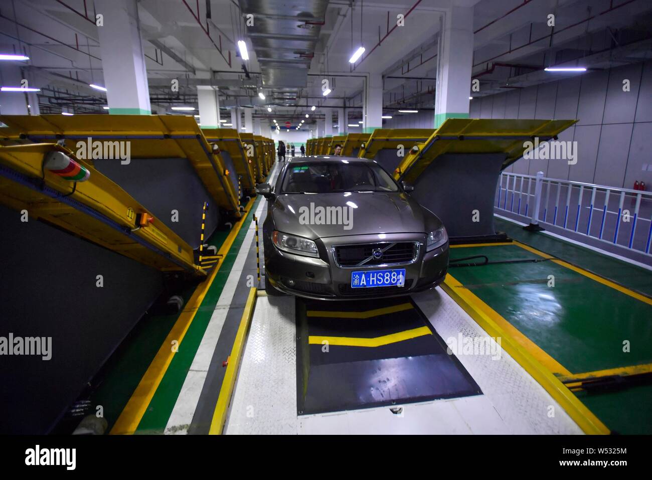 A local resident parks his car into an inclined position at a parking ...