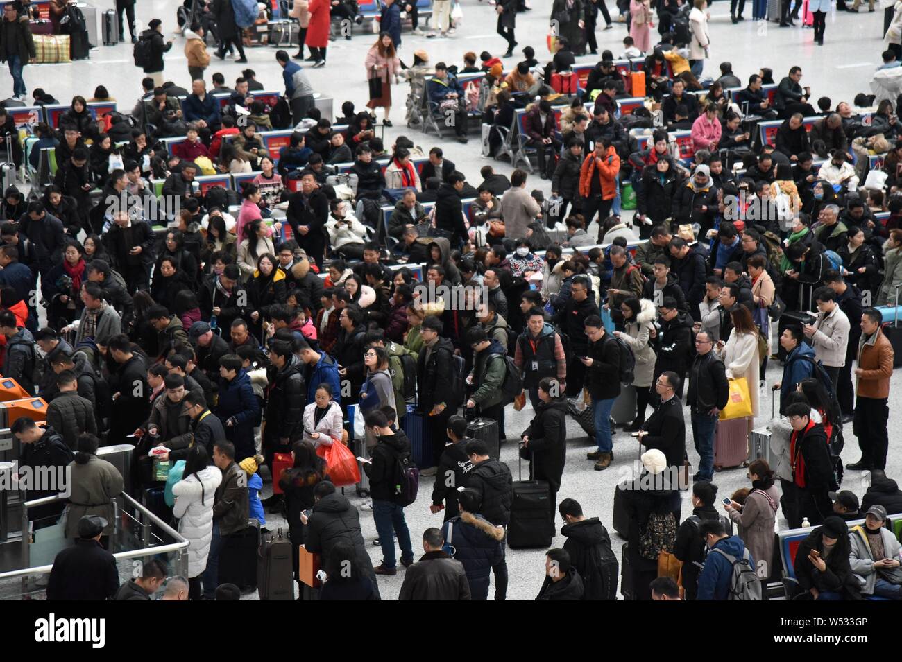 Passengers wait for their trains to go back home for the Chinese Lunar ...