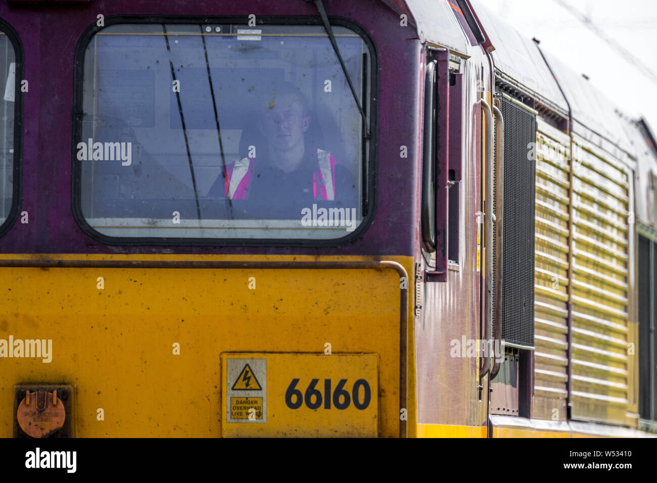 Freight train pulling empty trailers for carrying steel rail tracks ...