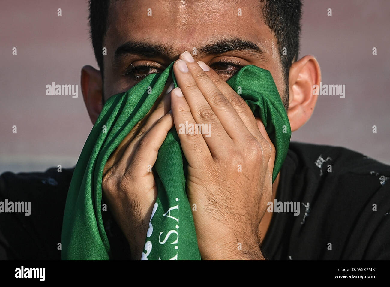A Saudi Arabian fan weeps after Saudi Arabia national football team was ...