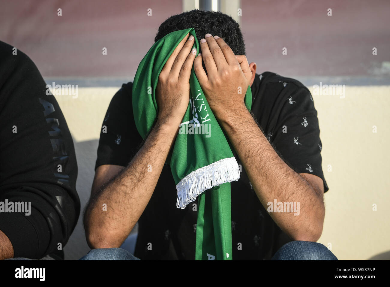 A Saudi Arabian fan weeps after Saudi Arabia national football team was ...