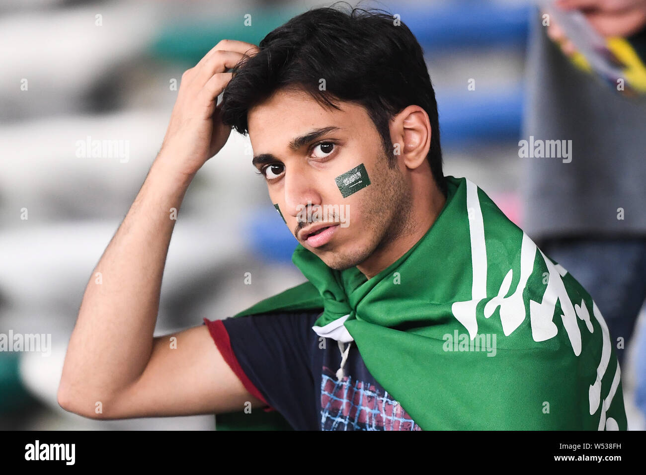 A Saudi Arabian football fan shows support for Saudi Arabia national ...