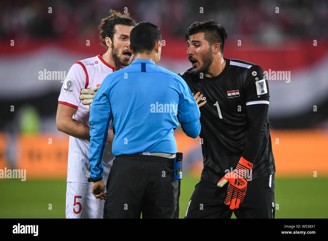 Goalkeeper Ibrahim Alma of Syria, right, argues with referee Cesar ...