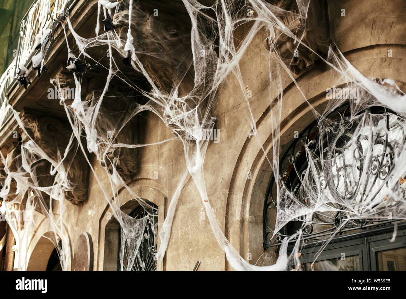 Halloween street decor. Spooky spider web on building facade in city ...